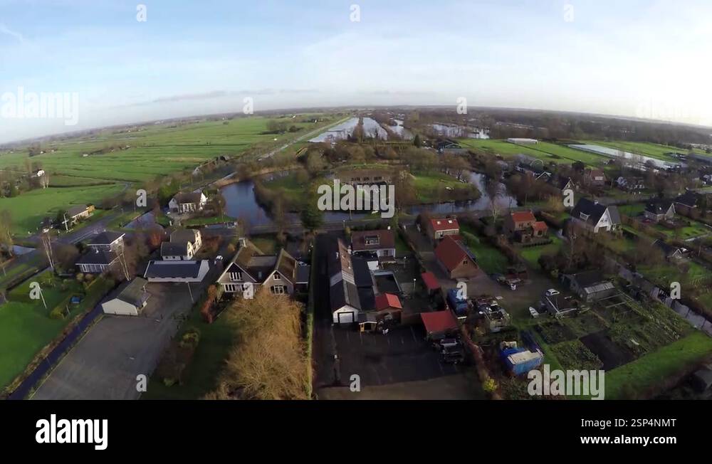 Aerial bird-eye helicopter view of a typical dutch village small houses ...
