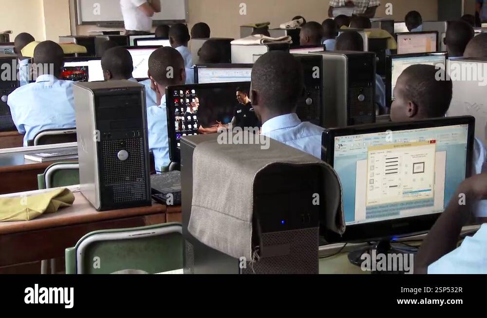 Rear view of African students study at computer lab of school ...