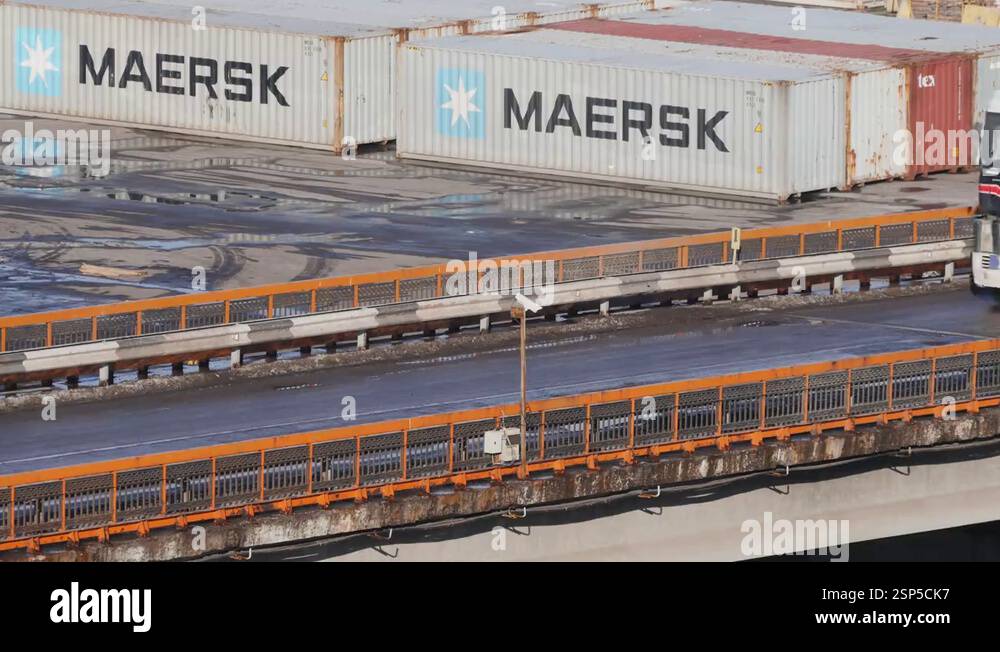 Empty container truck tractor driving on bridge in cargo terminal at ...