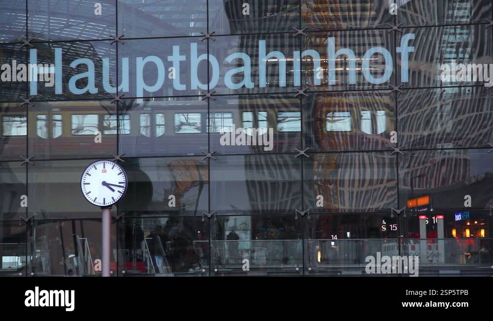 People, S-Bahn train leaving, Berlin Central station sign, clock ...