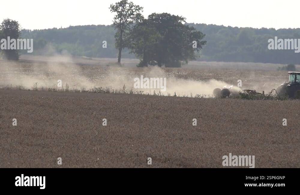 Tractor harrow agriculture field soil and heavy dust rise from dry ...
