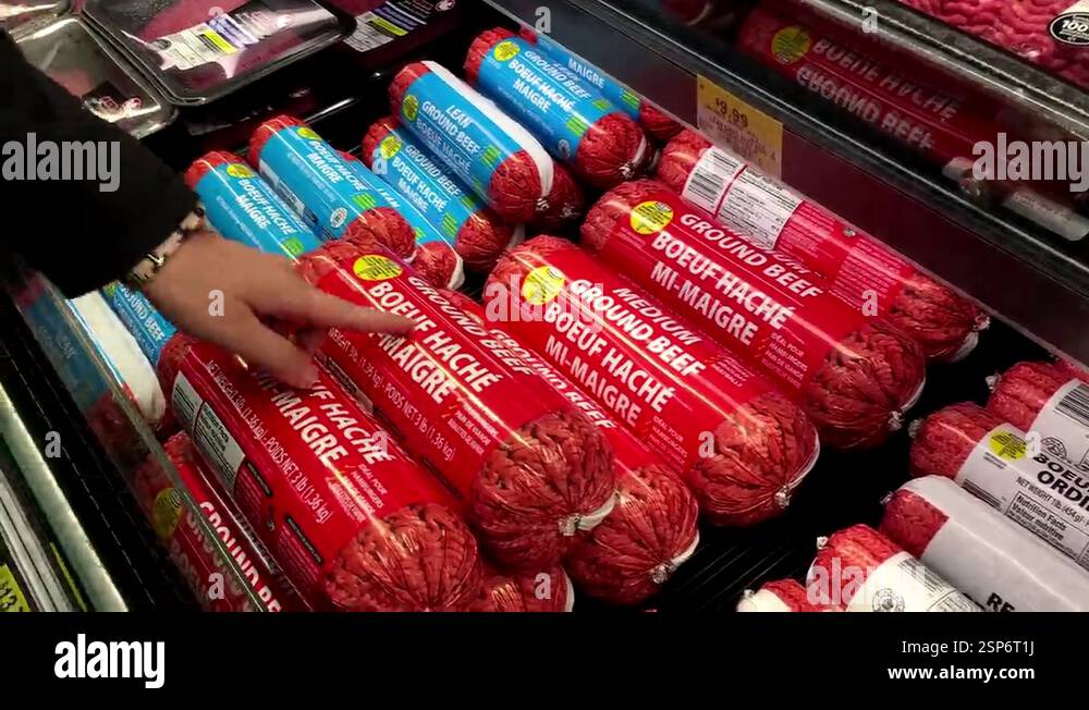 Woman selecting medium ground beef inside Walmart store at meat ...