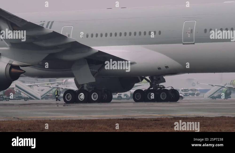 Wheels and turbines of an 777 300ER boeing moving on a runway in the ...