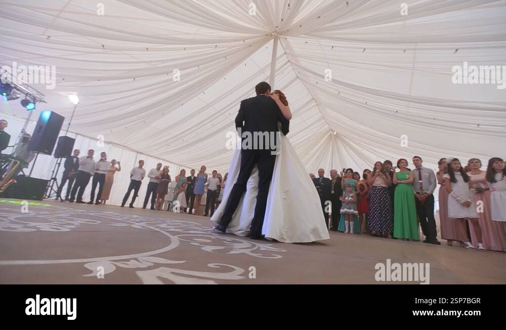 bride and groom share their first dance together on their wedding day ...