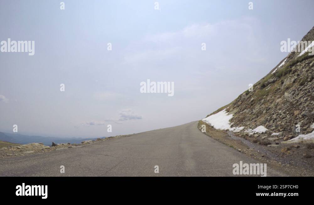 Car driving on paved road above timber line on Mount Evans-POV point of ...