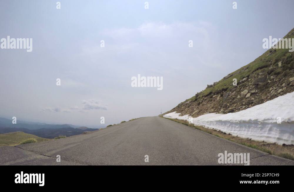 Car driving on paved road above timber line on Mount Evans-POV point of ...