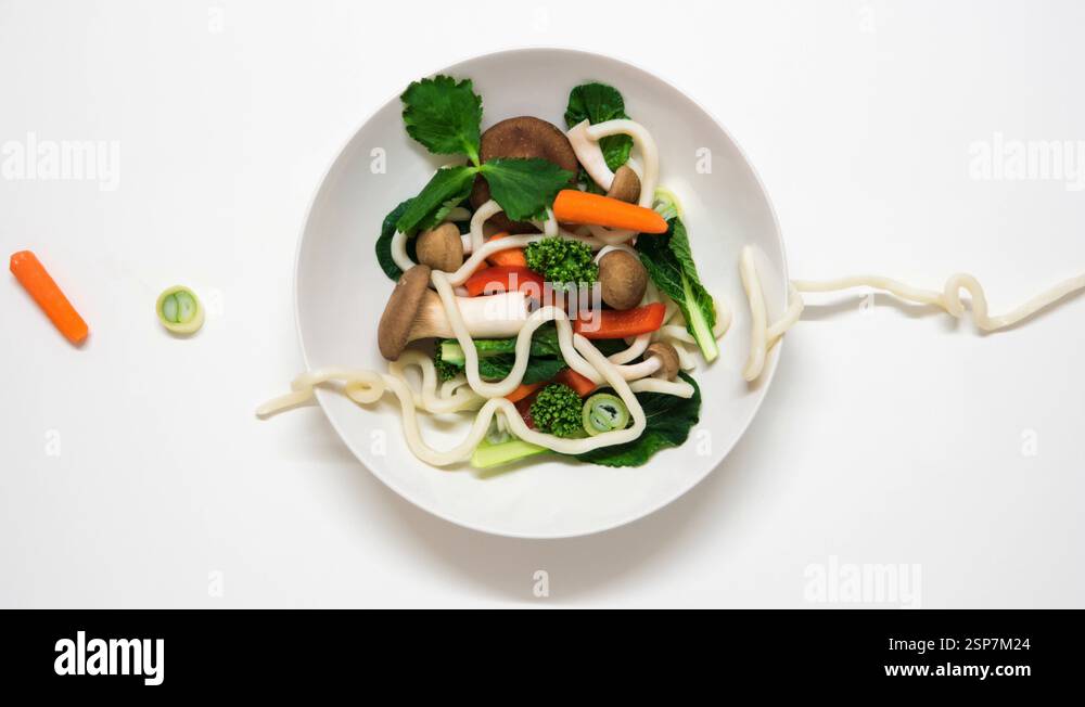 Vegetables and udon noodles becoming a soup.Stop motion animation. 4K ...