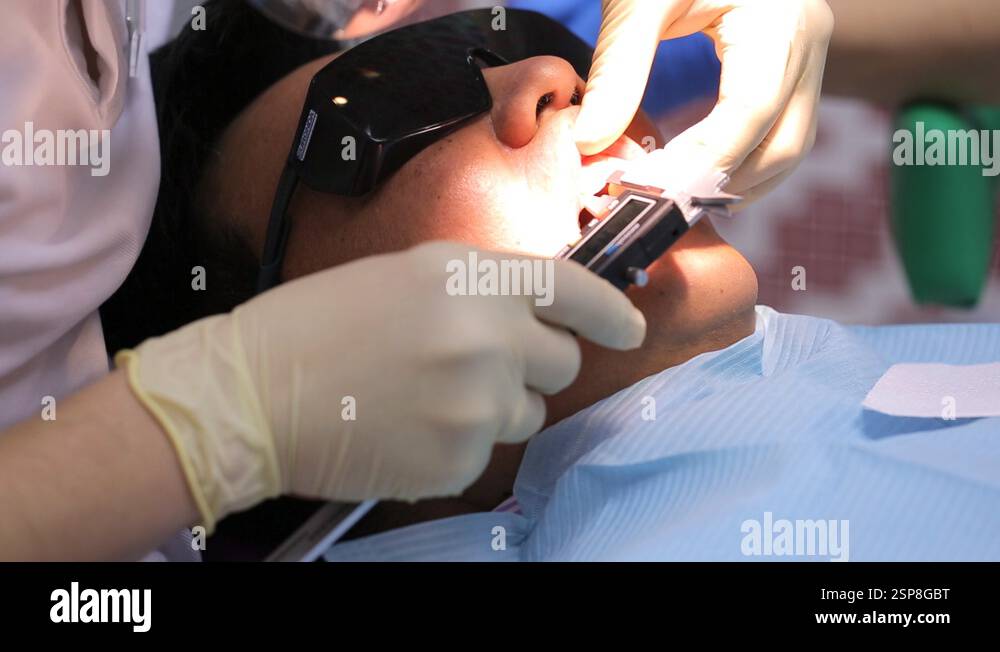 Dentist measures using electronic vernier caliper dimensions of tooth ...
