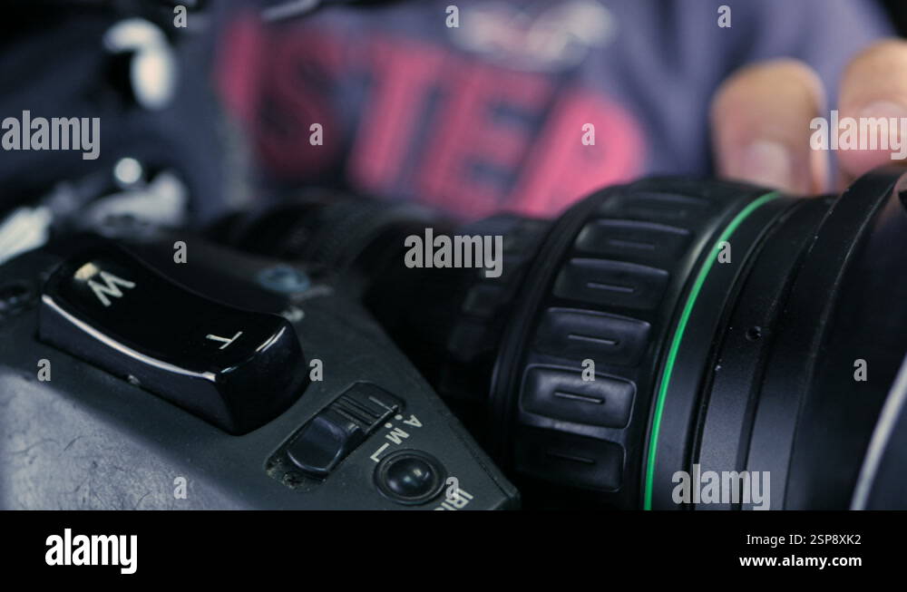Studio camera. Cameraman changing camera settings focal length ...
