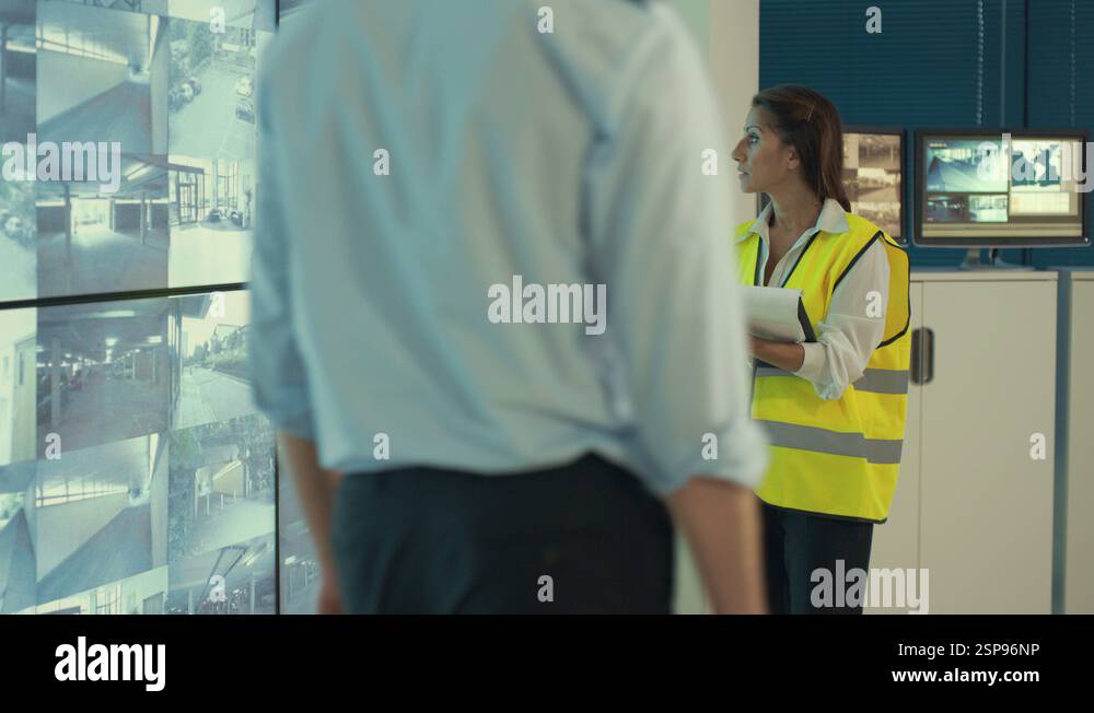 4K Female surveillance officer watching the screens in observation ...