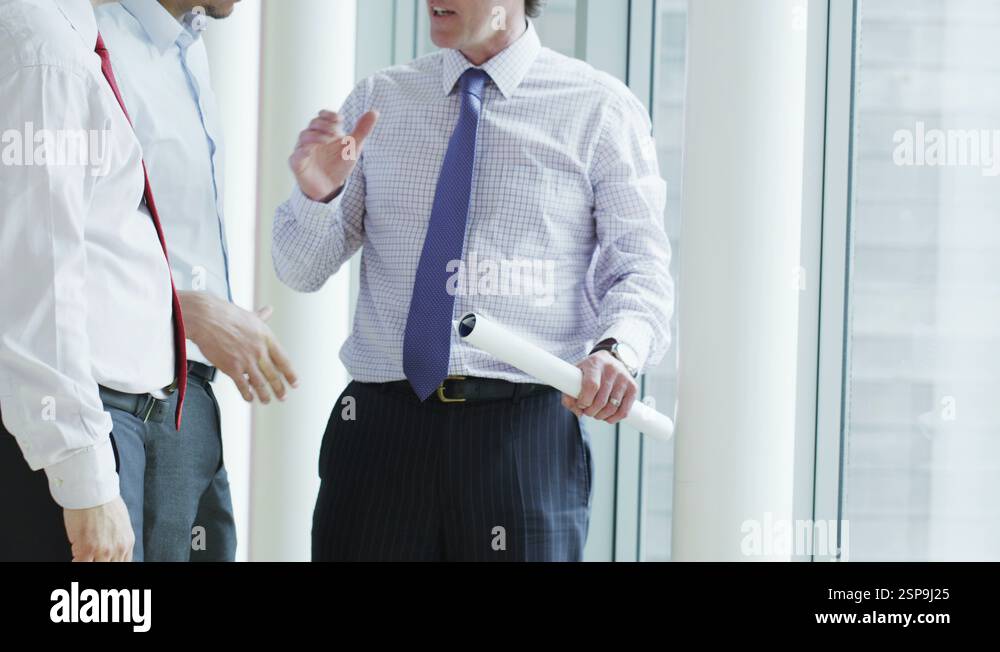 4K Architects looking at building plans & having a discussion in modern ...