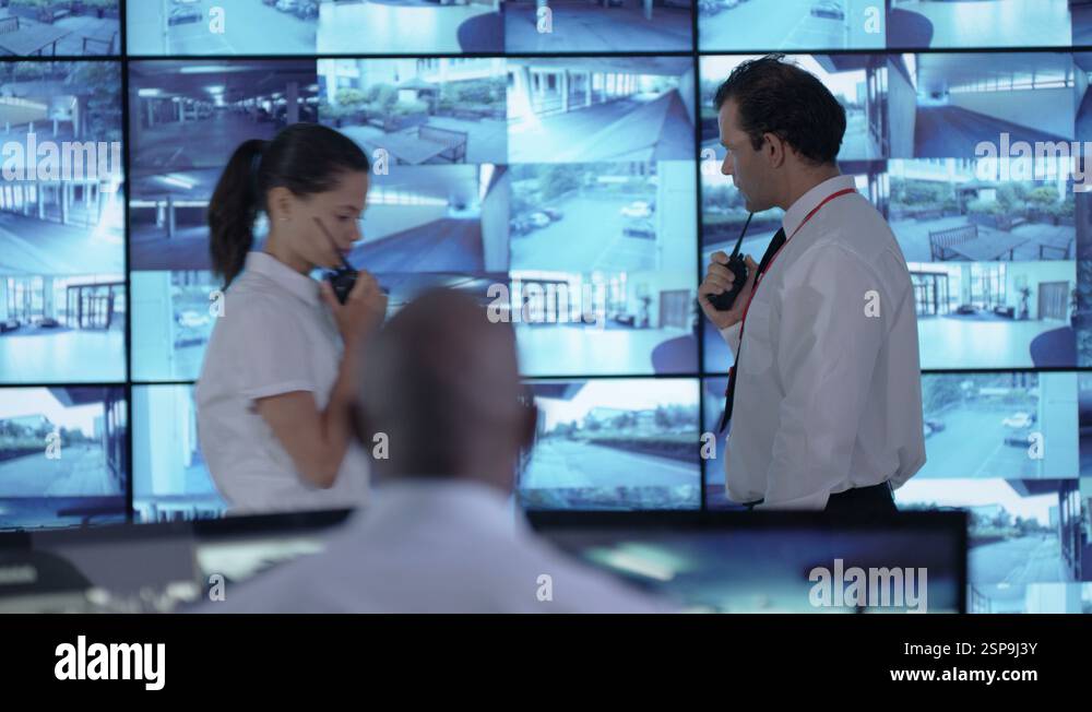 4K Surveillance team watching CCTV screens & reacting to suspicious ...