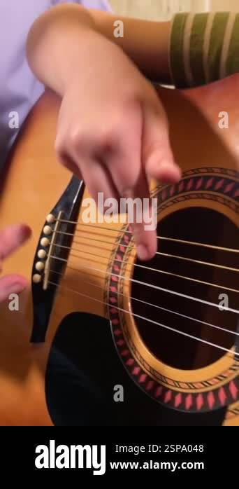 Vertical a young music teacher guides a child in learning to play the ...