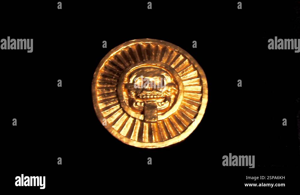 Golden image of Aztec god of death (mictlantecuhtli). In man's hands ...