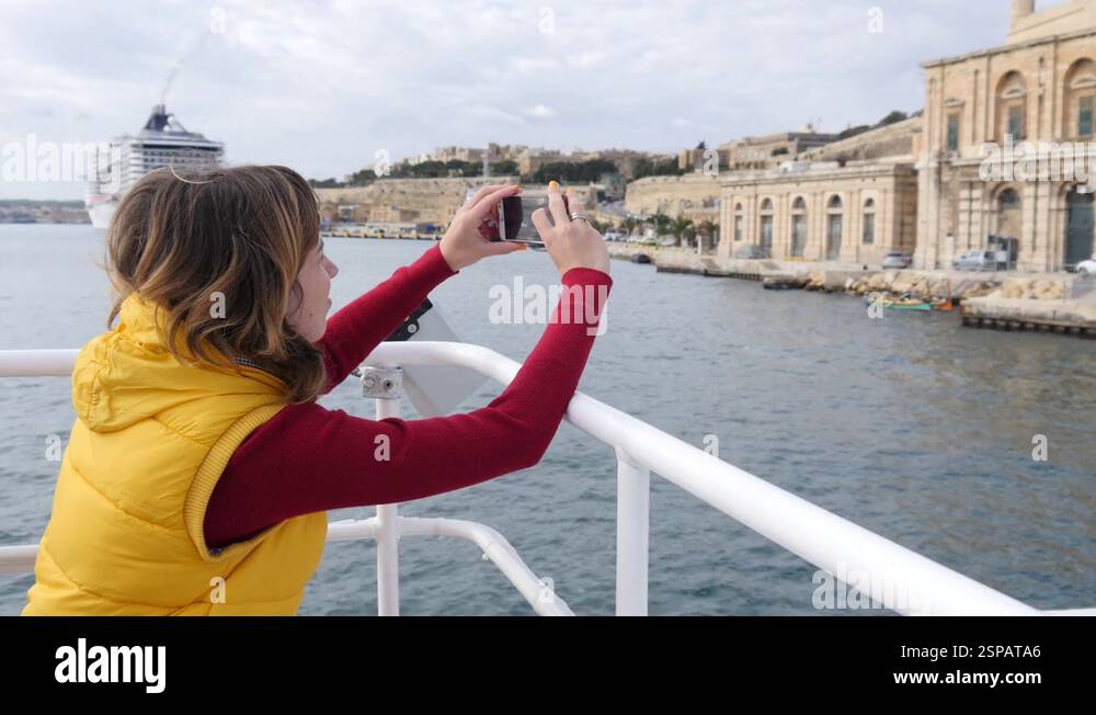 Valletta, Malta - woman tourist take picture of city line from moving ...