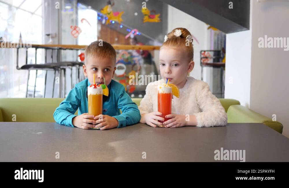 Milkshake cocktail - children in cafe, cute little girl and boy drink ...