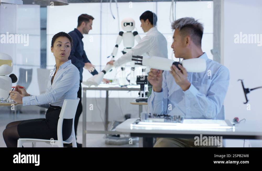 4K Technical design team working on construction of robot in modern lab ...