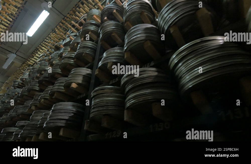 Film Archive. Films, movie reels on a shelfs in a huge old movie ...