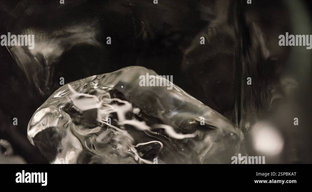 Macro liquor / alcohol poured on ice, ice cube inside of a glass Stock ...