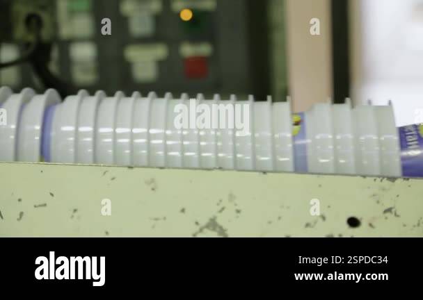 Plastic container production line. Stacks of plastic cups on a conveyor ... Plastic container production line. Stacks of plastic cups on a conveyor ...