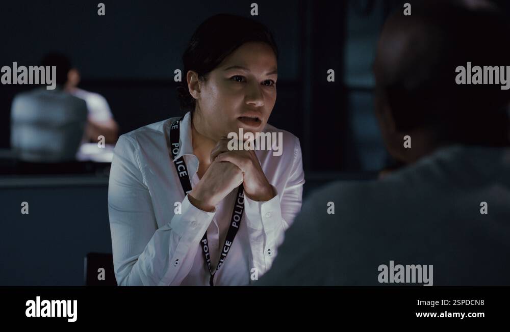 4K Female police detective questioning a crime suspect & showing him ...