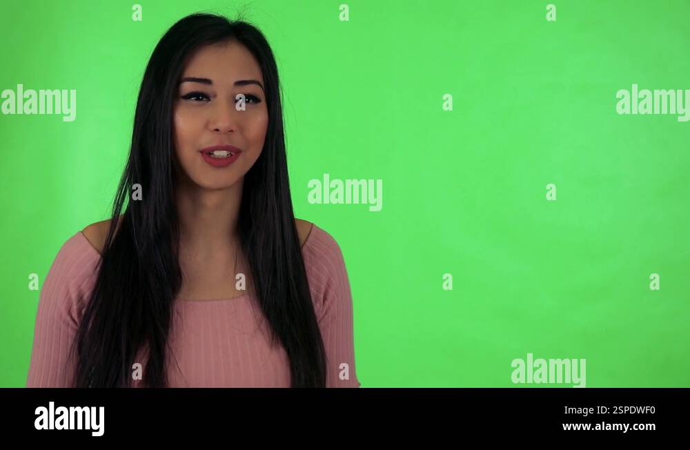 young attractive asian woman blows her nose into a handkerchief - green ...