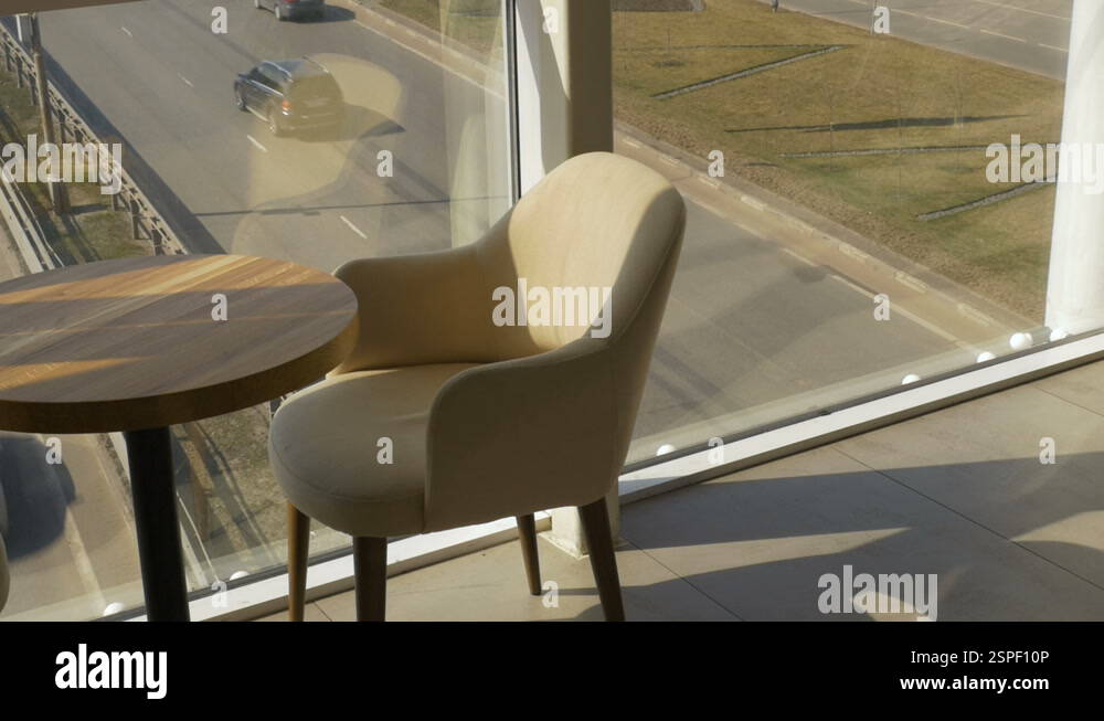 A view of the cafe through a glass window, the road on which cars are ...