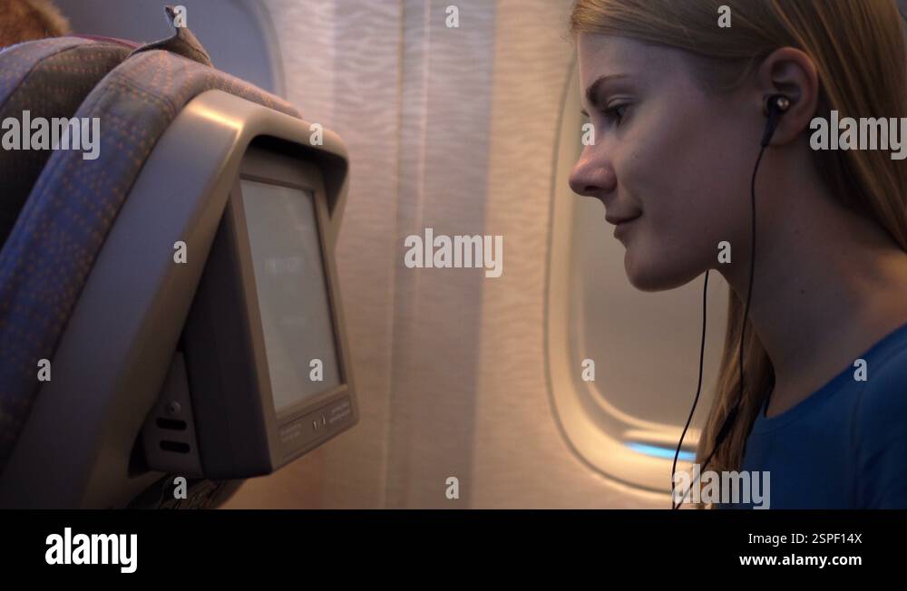 Beautiful attractive woman near airplane window. Long distance flight ...