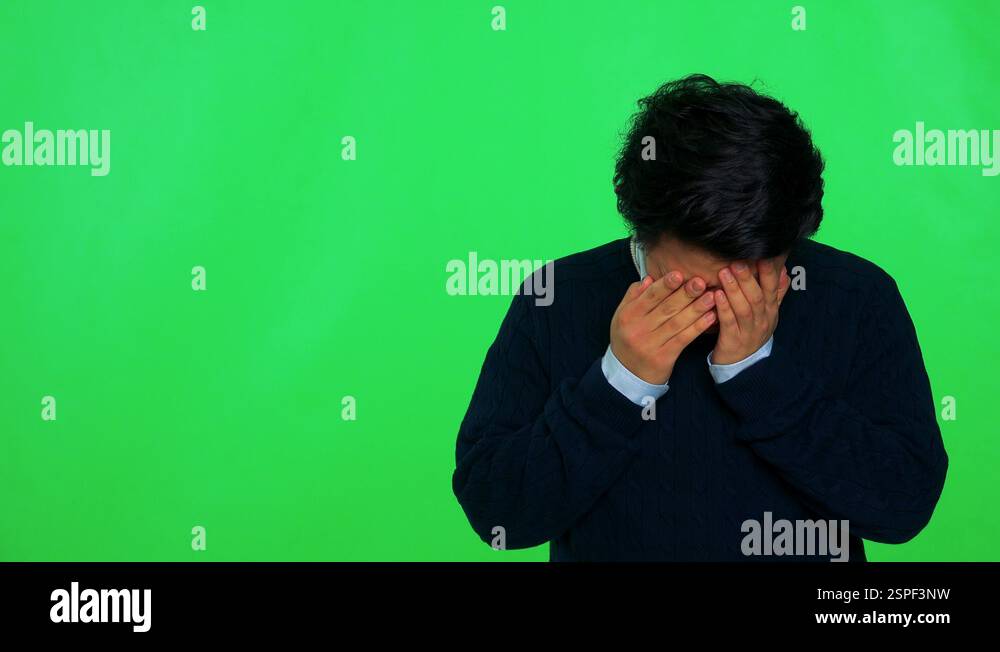 A young Asian man crying - green screen studio Stock Video Footage - Alamy