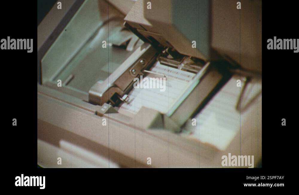 1960s: paper in printer. Man gets into car. Cars on road. People in ...