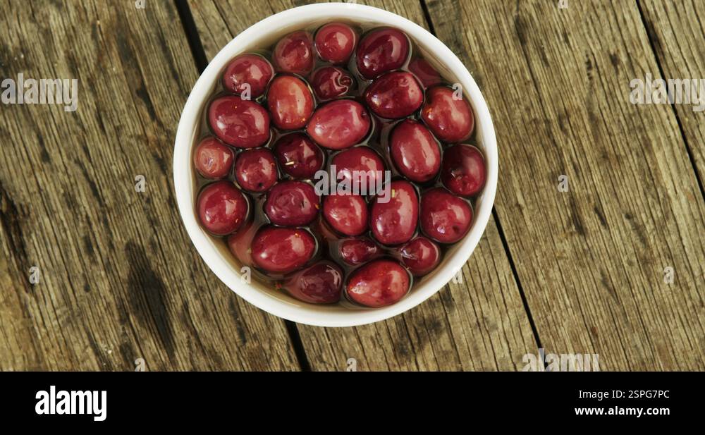 Red olives marinated in oil Stock Video Footage - Alamy