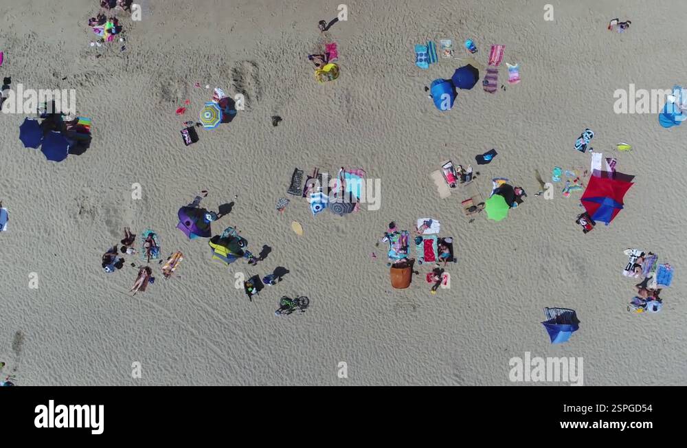 Aerial top down view of white sand beach with people sun bathing sunny ...