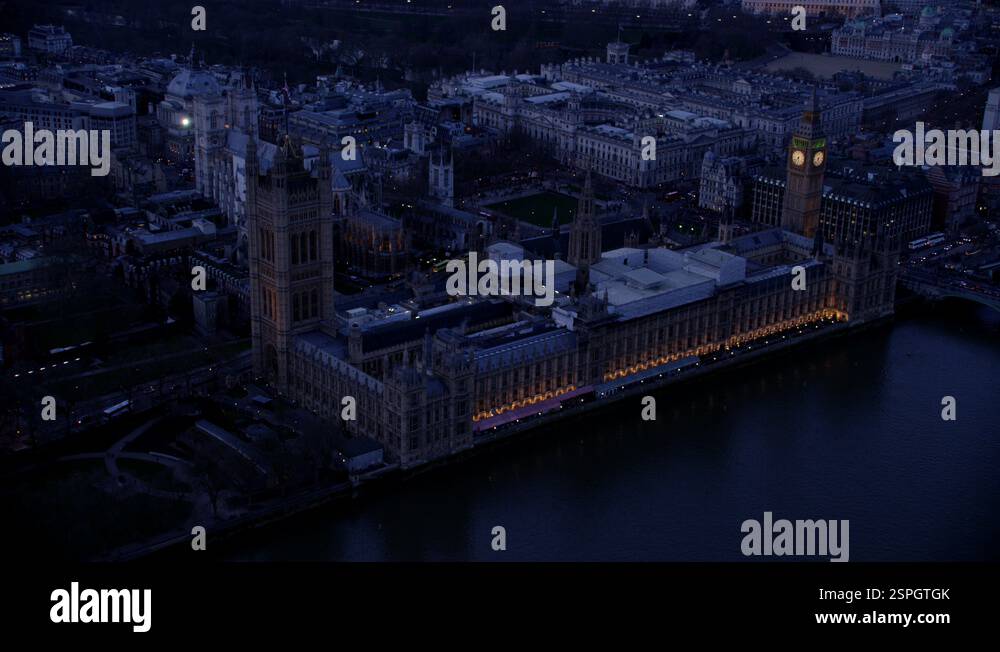 4K Aerial view of London's Big Ben & Houses of Parliament lit up early ...