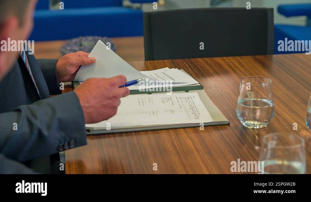 Signing a contract and handing over a pen to his business partner Stock ...
