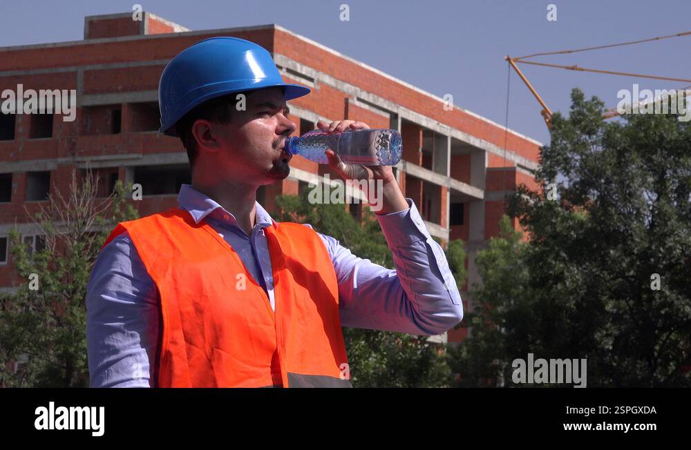 Thirsty foreman inspector with hardhat drinking water construction lunch break Stock Video ...