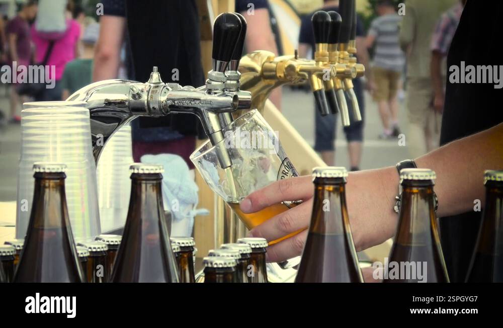 Open air beer festival at one of sales point barman hand hold glass ...