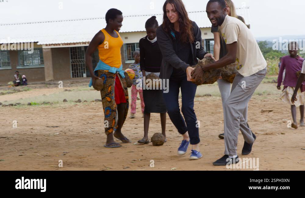 Charity workers working on African community project with children ...