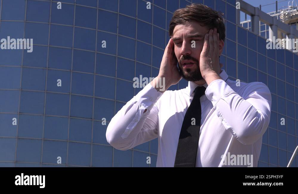 Headache businessman outdoors rubbing temples ill sick overworked ...