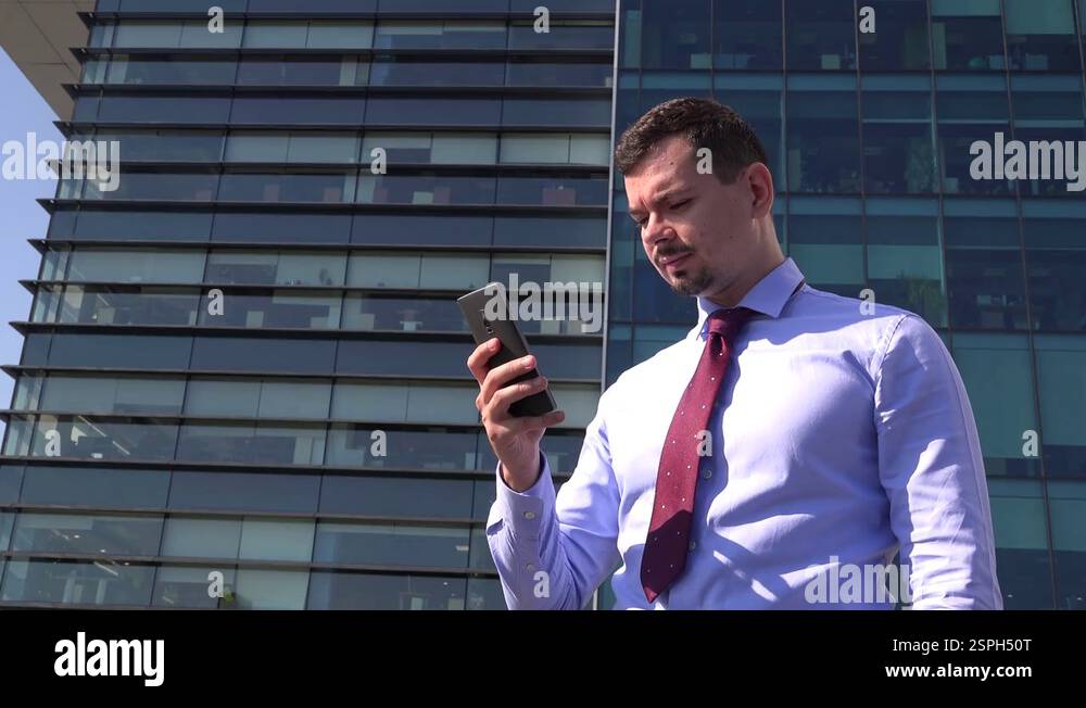 Confused business man outside checking smartphone navigation looking ...