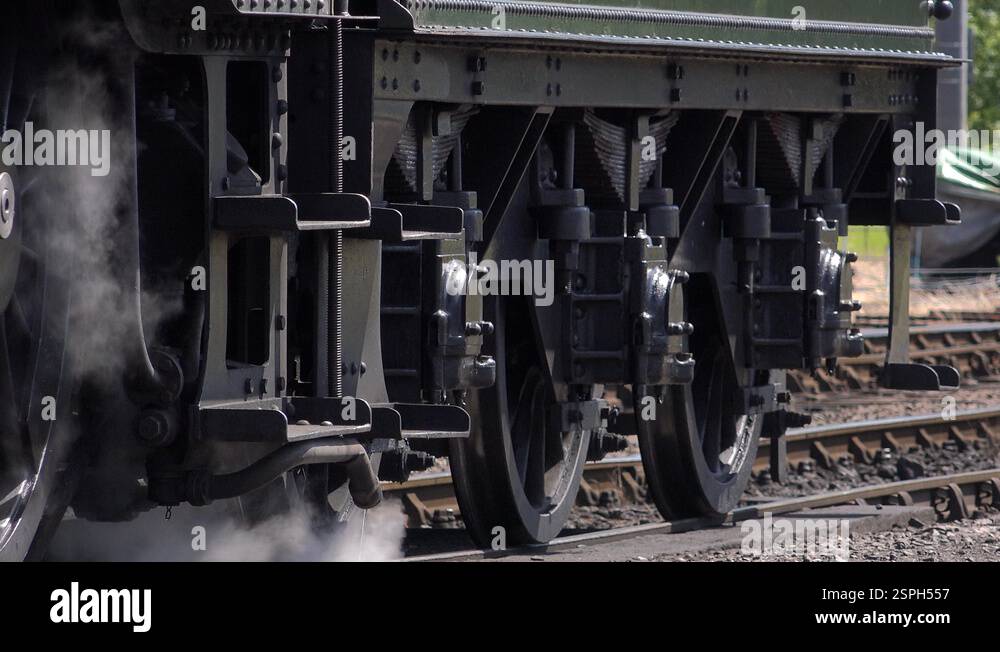 Steam Train starting off from station 4k shot low level of wheels Stock ...