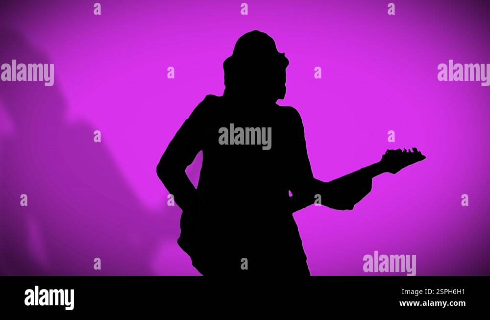 Cool Guitarist is Playing the Electric Guitar on the Pink Background ...