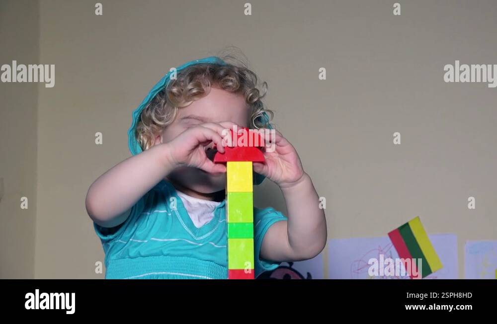 little boy child construction toy bricks building a tower. Children at ...