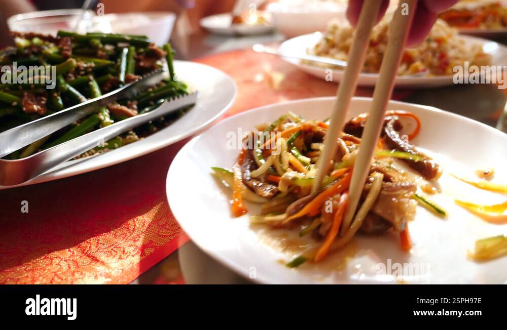 People eat Chinese food in a Chinese restaurant. close-up. Slow motion ...