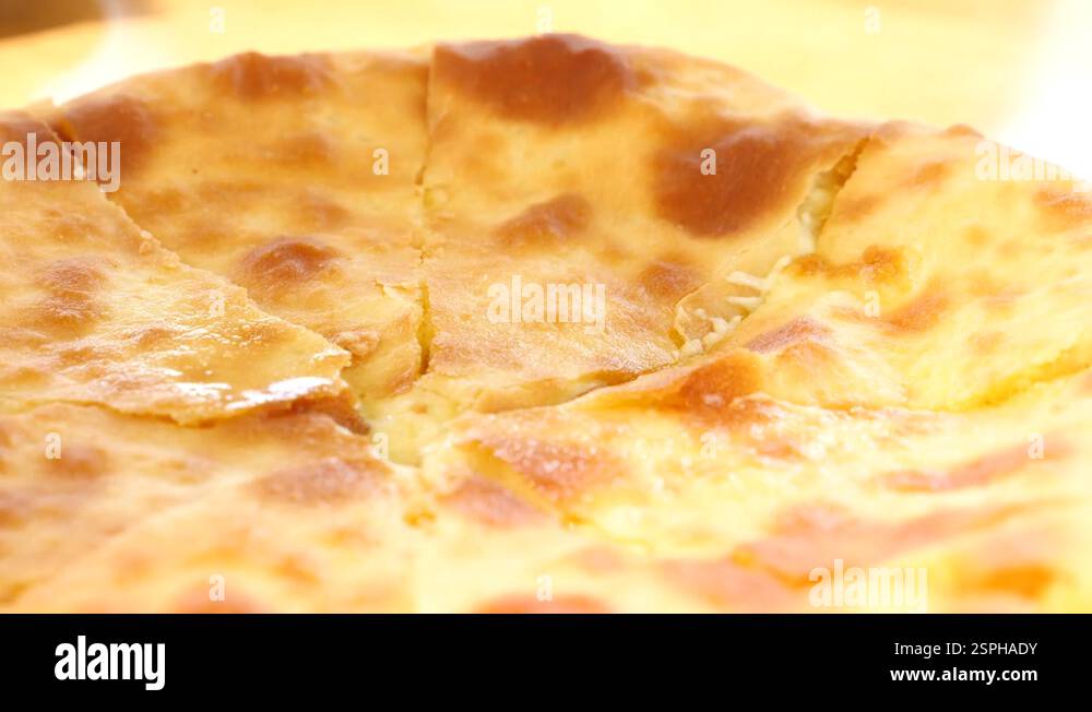 georgian khachapuri megruli with cheese. Someone takes a piece of ...