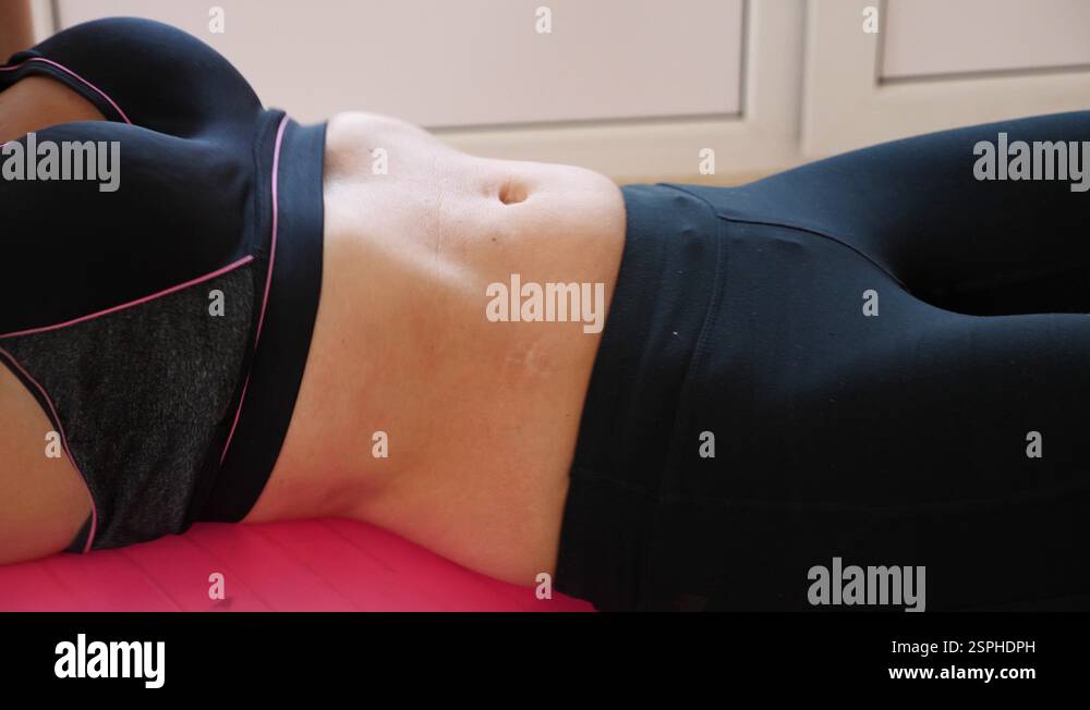 The woman trains on fitball, Close-up, slow-motion. Movement of the ...