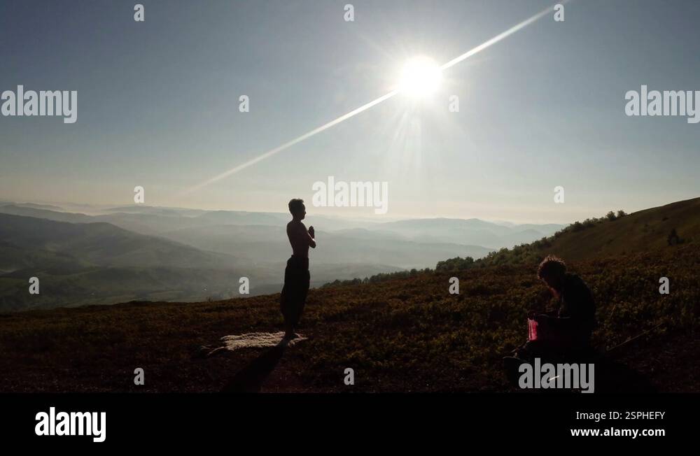 Yogi prays, stretches to the rays bowing to the sun in the morning in ...