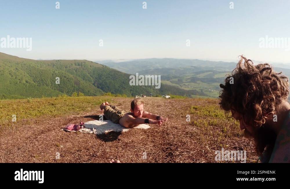 Yogi doing exercises lying on his stomach in the mountains, you can see the head Stock Video ...