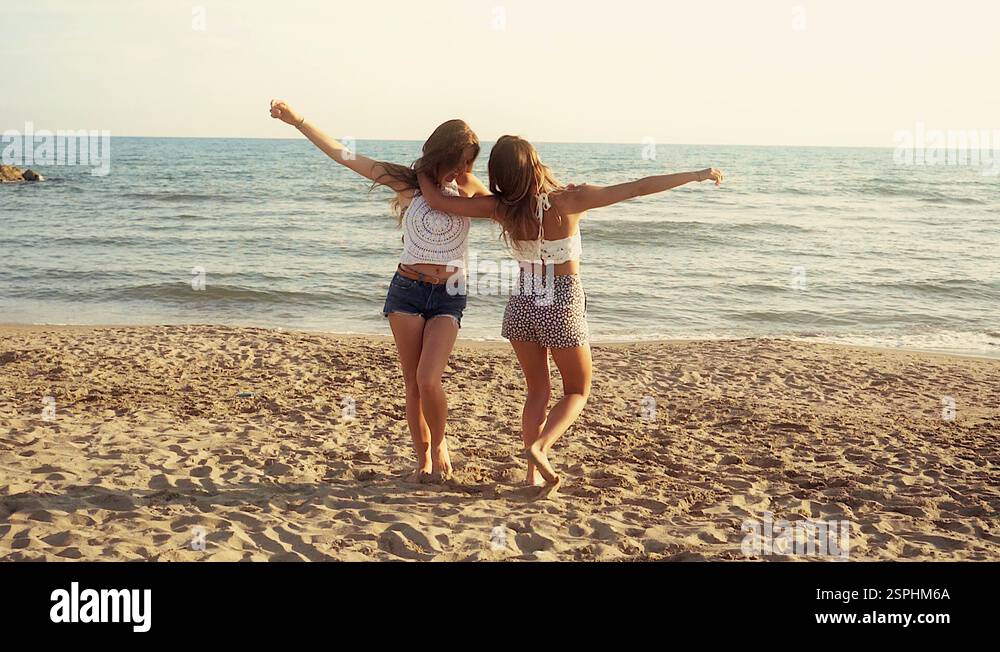 Happy cute girls dancing on the beach in summer having fun dream ...