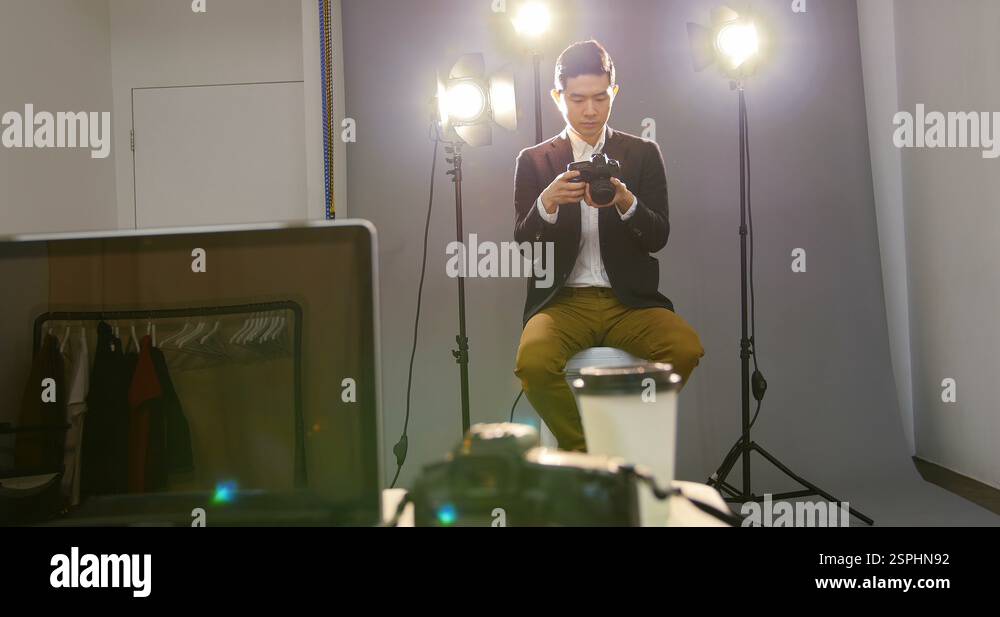 Male photographer reviewing captured photos in his digital camera Stock ...