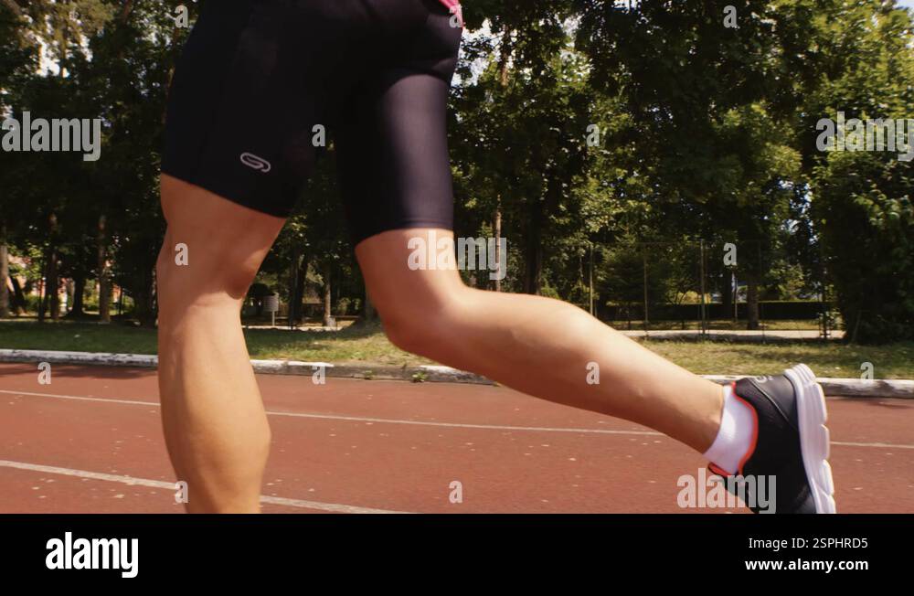 Slow motion shot of a man on a running track in the park Stock Video ...
